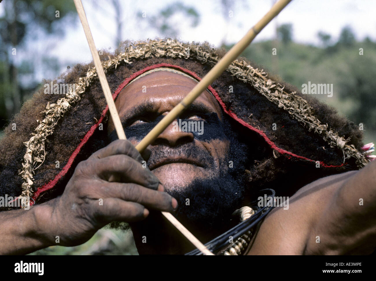 Huli tribesman firing arrow Tari Eastern Highlands Papua New Guinea ...