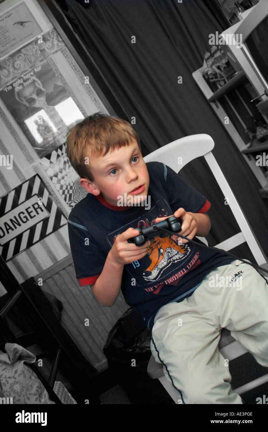 Boy Playing On Games Consul Stock Photo - Alamy