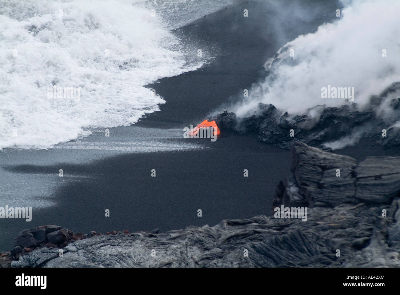 Hot lava flowing onto beach and into the ocean, Kilauea Volcano, Hawaii ...
