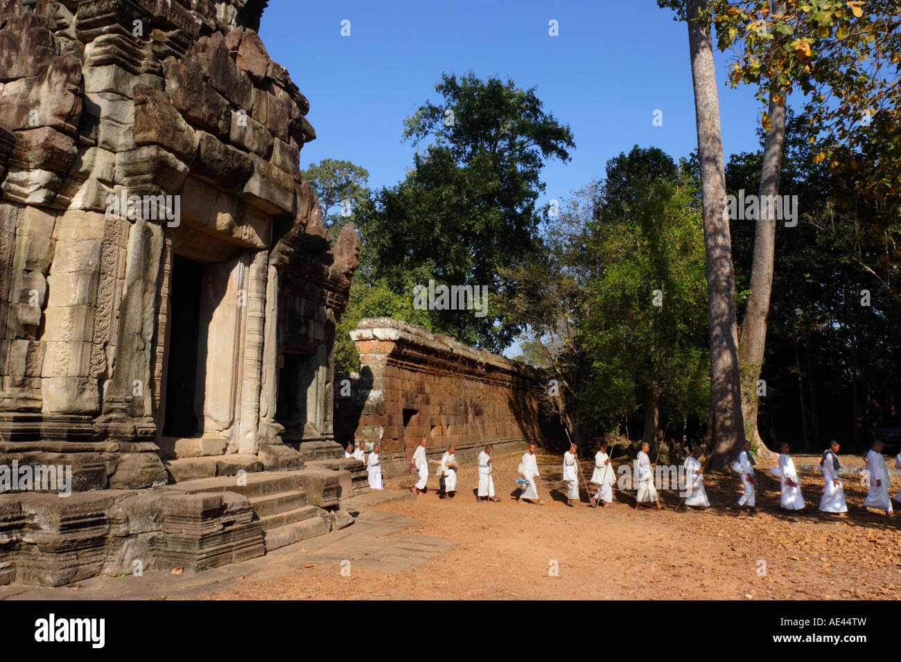 A procession of Buddhist nuns file through the temples of Angkor ...