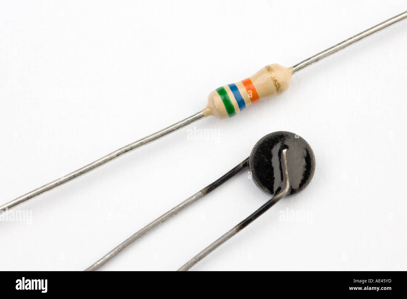 A disc type thermistor next to a resistor to show scale Stock Photo - Alamy