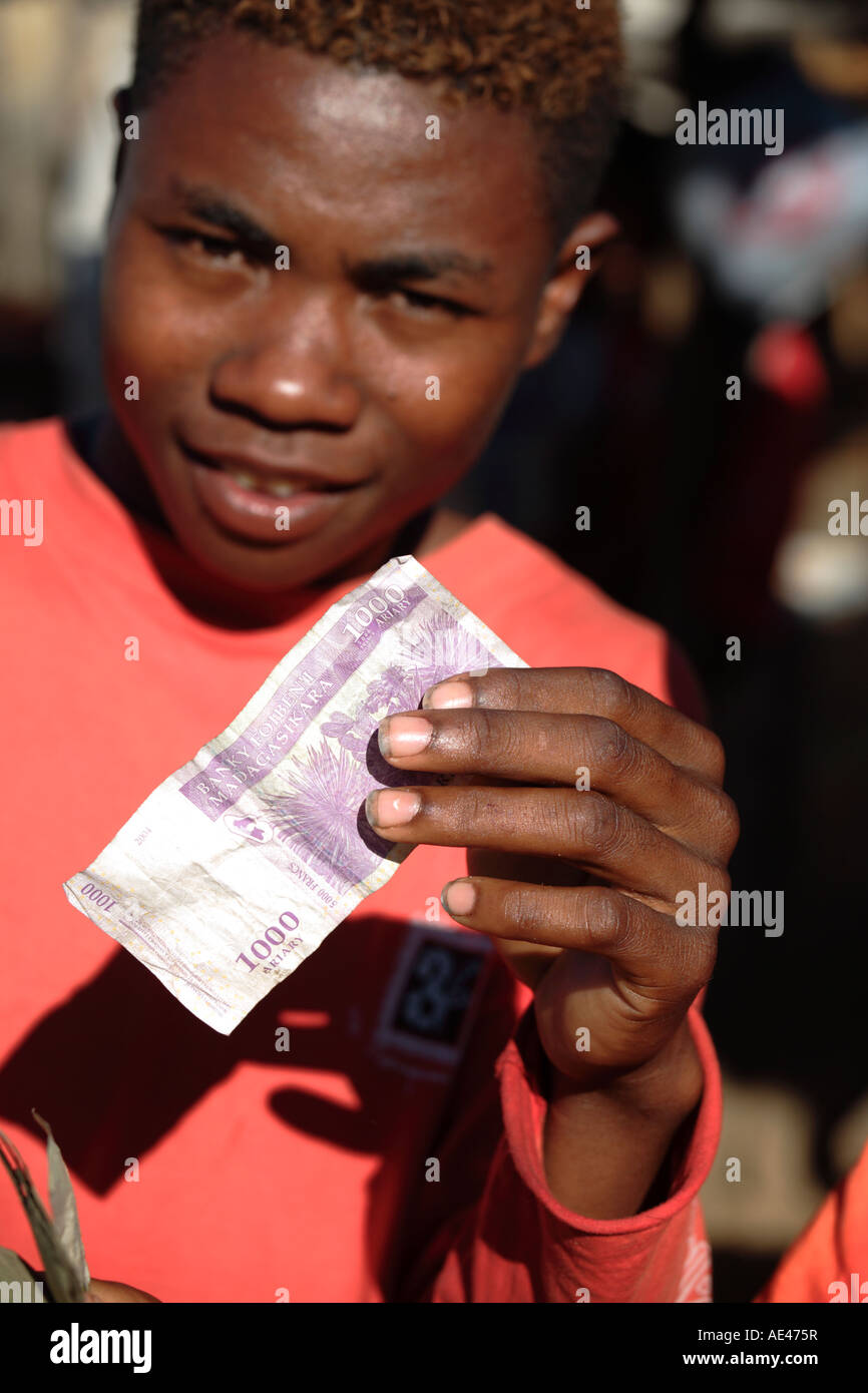 Boy showing 1000 Ariary, Malagasy currency, Madagascar Stock Photo - Alamy