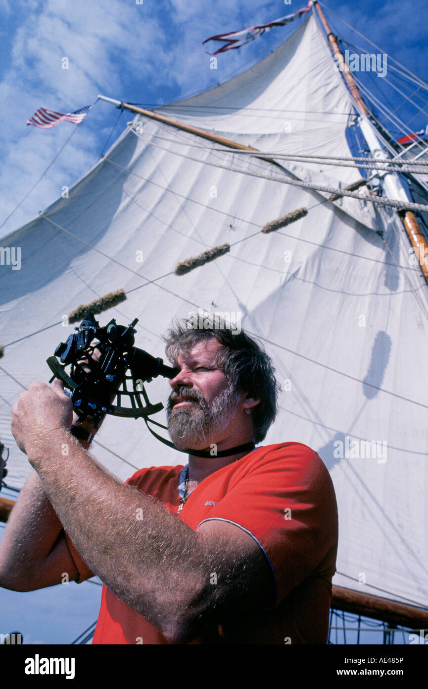 A sailor collects a navigational sun line on a sextant of the square ...