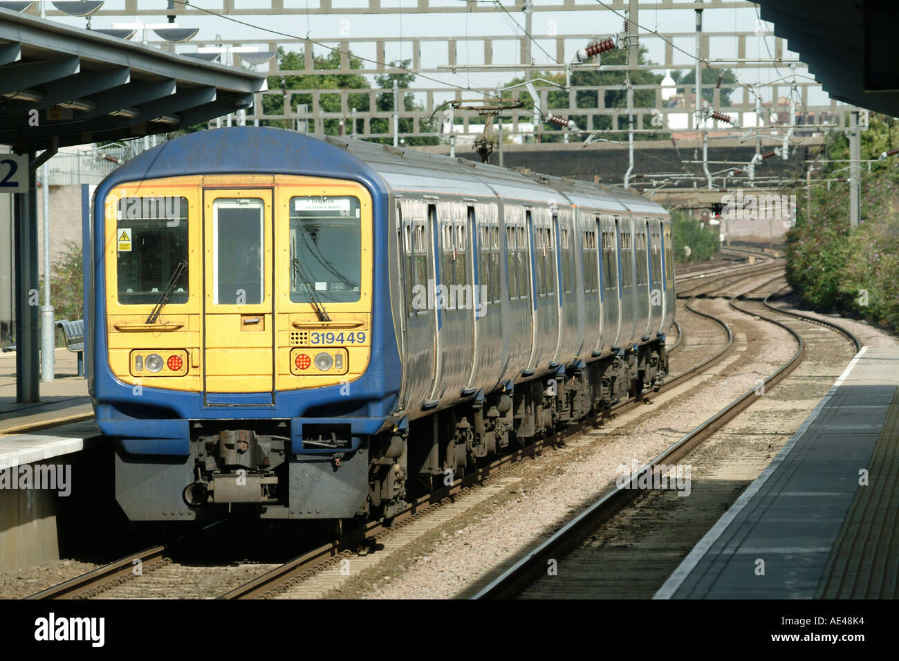 Thameslink class 319 passenger train at a railway station in the UK ...