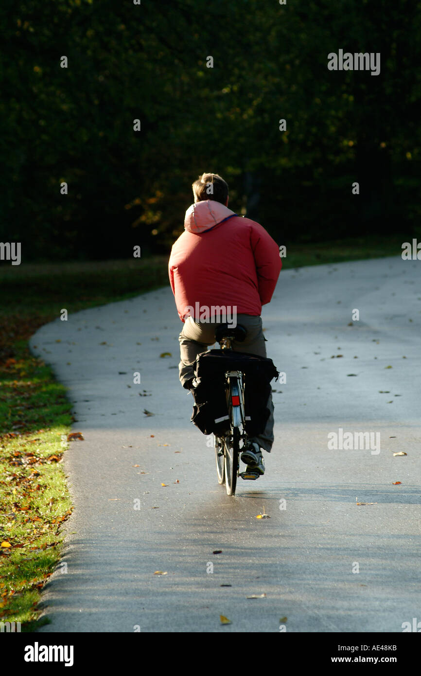 Cyclist on a bicycle cycling along a cycle path in the UK Stock Photo ...