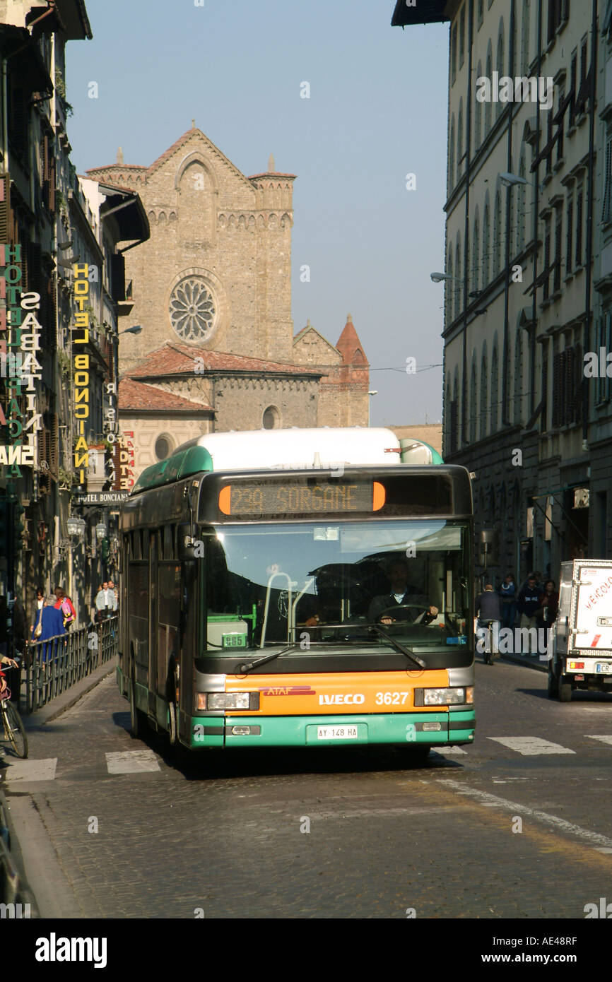 Gas powered bus travelling along a street in the city of Florence Italy ...