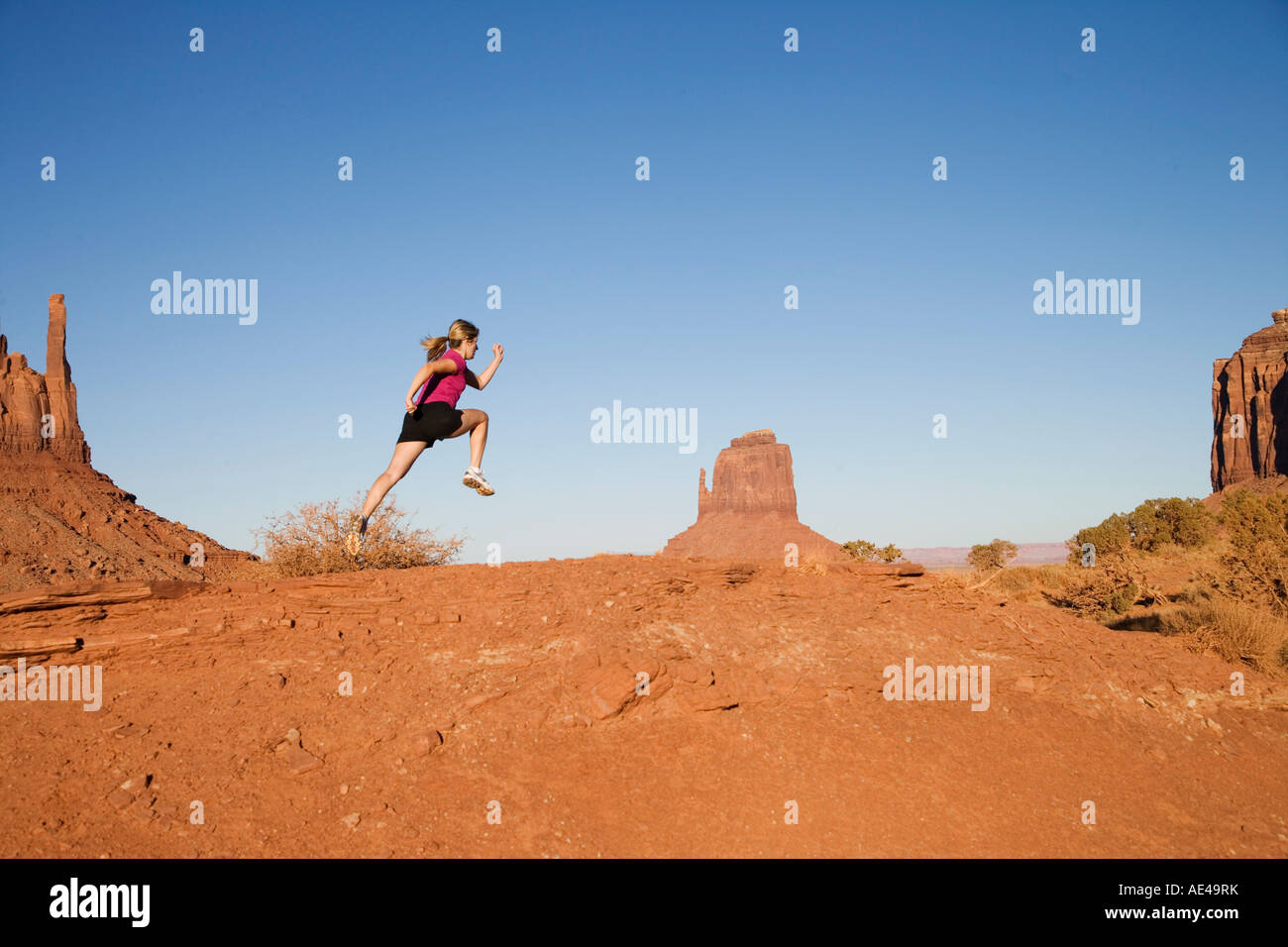 Woman jogging, Monument Valley Navajo Tribal Park, Utah Arizona border ...