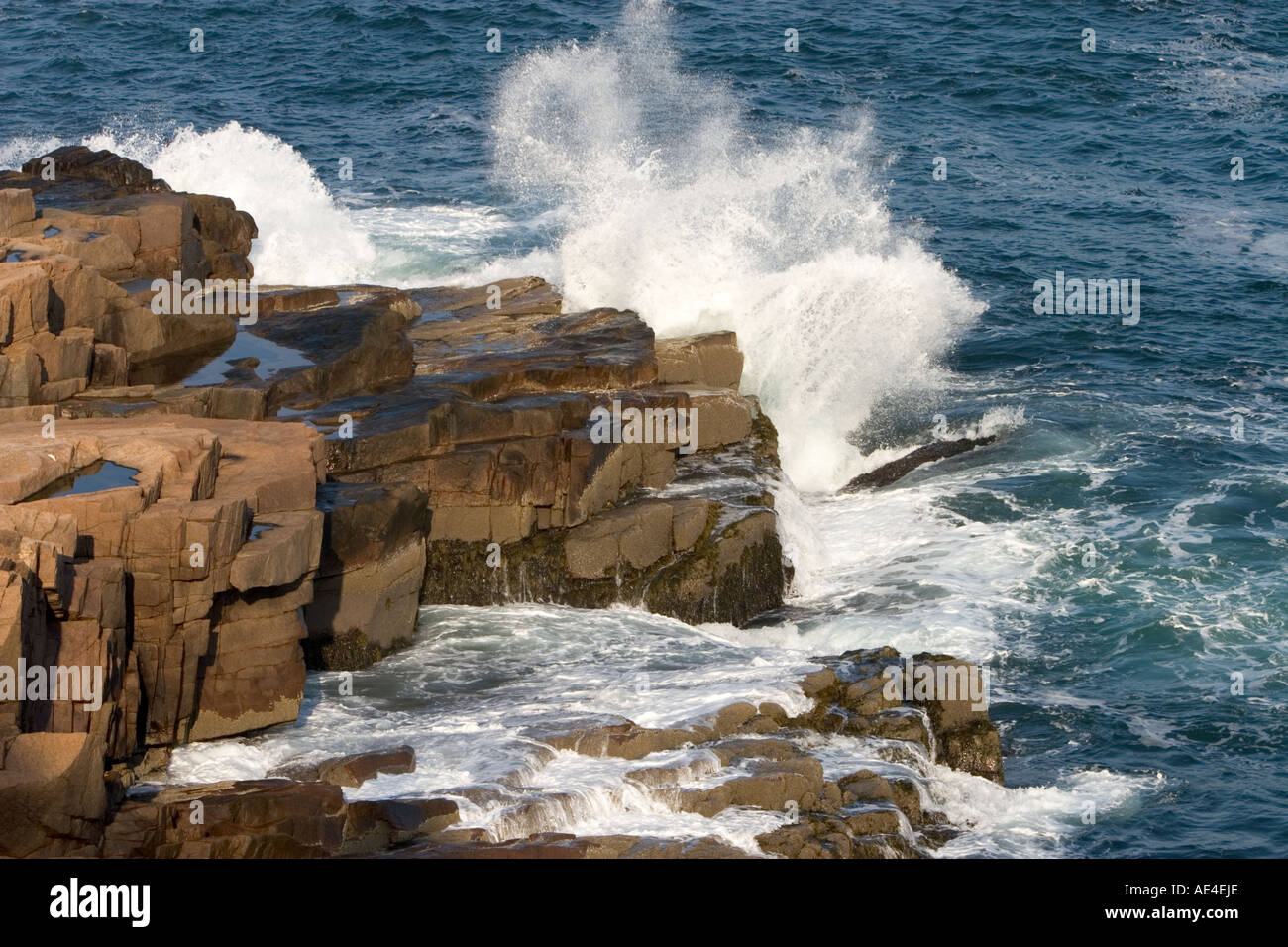 Wave crashing along shoreline cliffs Stock Photo - Alamy