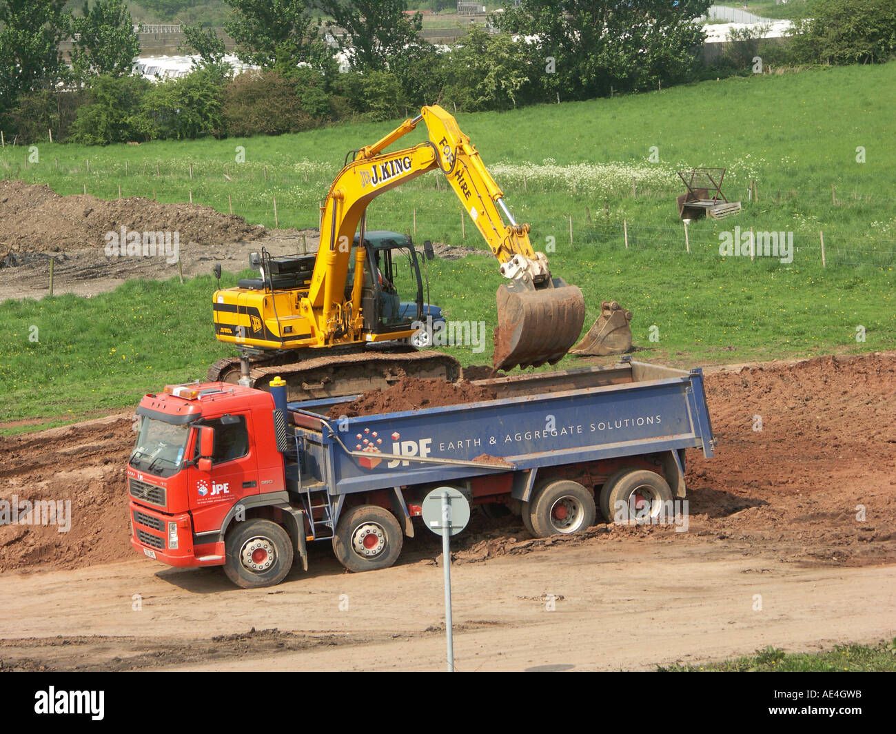 Excavator loading earth onto a lorry Stock Photo - Alamy