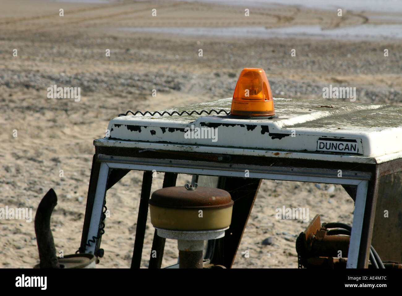 Orange revolving safety warning beacon mounted on old tractor cab Stock ...