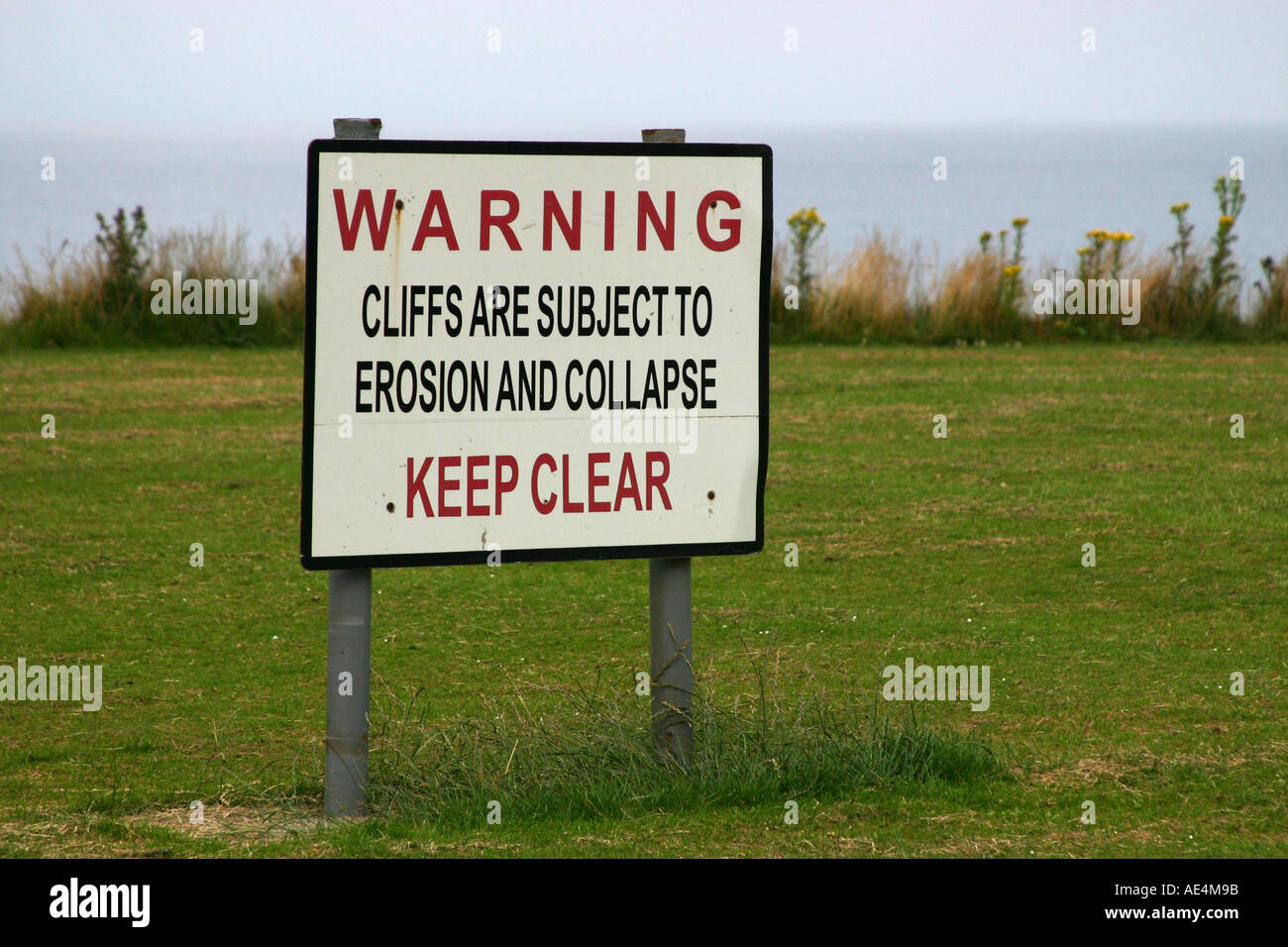 Warning sign on soft clay cliff top at Skipsea in North Yorkshire ...