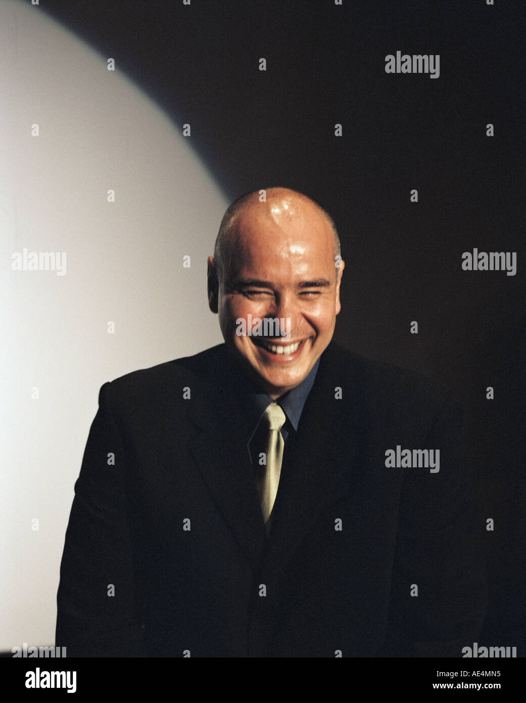 Happy Comedian in suit on stage Stock Photo - Alamy
