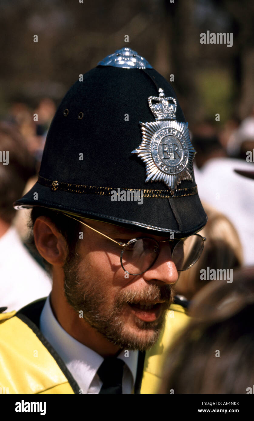 Metropolitan Police officer with beard glasses and high visibility vest ...