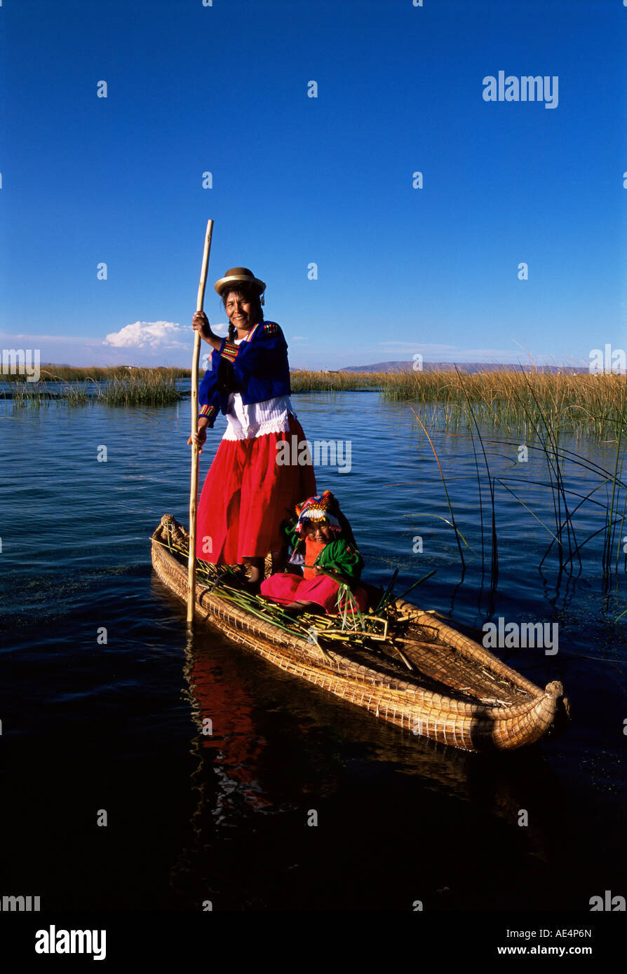 Uros Indian woman and traditional reed boat, Islas Flotantes, Lake ...