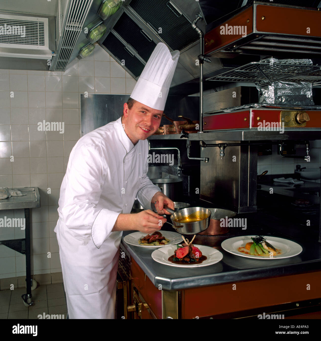 Chef preparing food in kitchens with stove oven Stock Photo - Alamy
