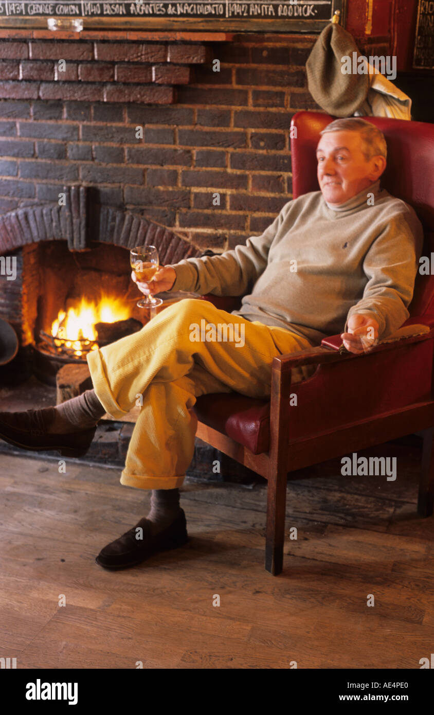 man sitting by fire in Two Brewers Pub Windsor UK Stock Photo - Alamy
