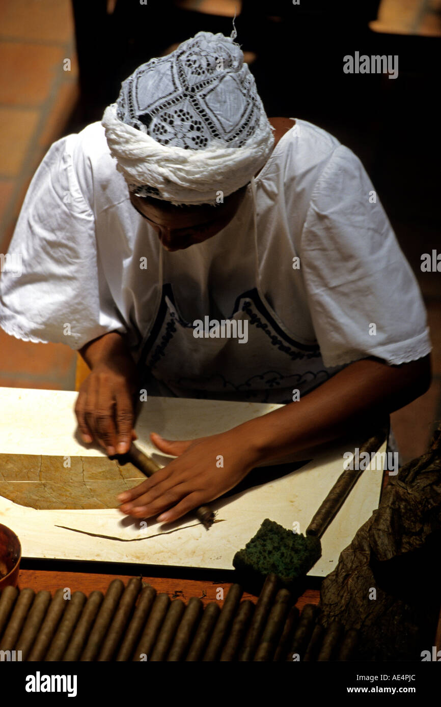 Woman in traditional costume rolls cigars at Dannemann cigar factory in ...