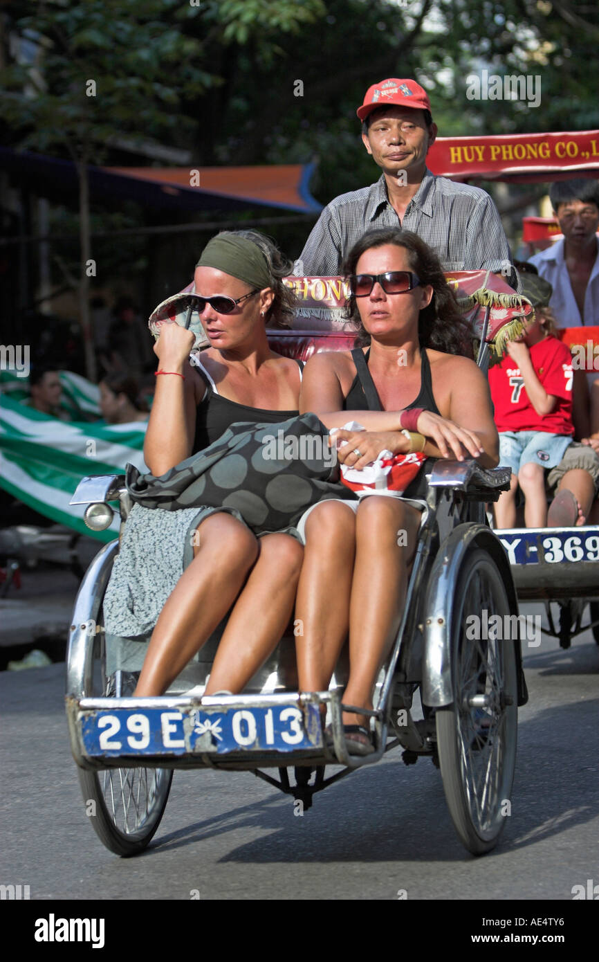 Two women tour Hanoi Old Quarter by cyclo rickshaw Vietnam Stock Photo ...