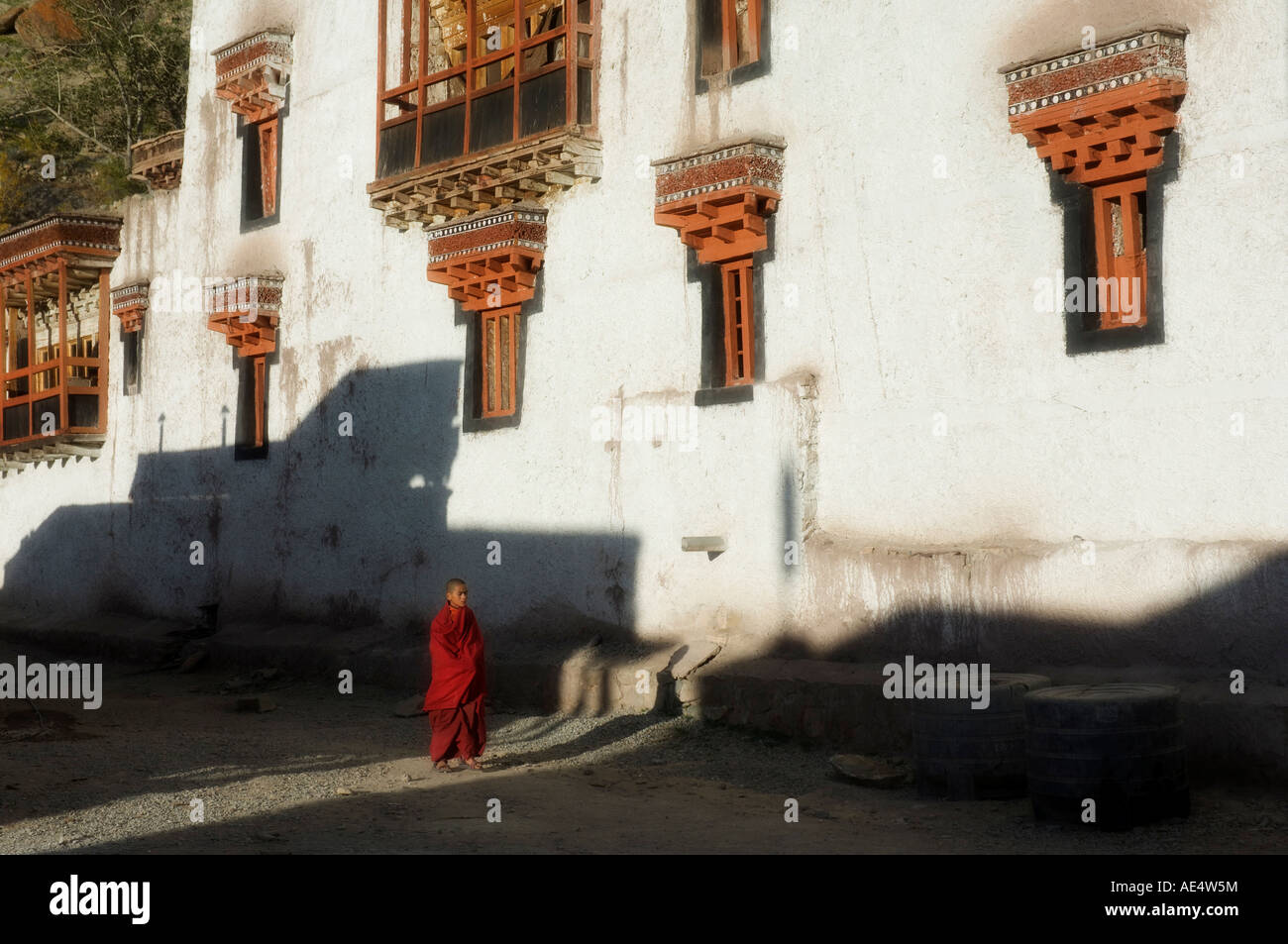 Buddhist monk walking past Hemis gompa (monastery), Hemis, Ladakh ...