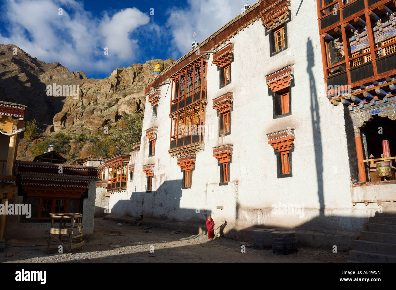Buddhist monk walking past Hemis gompa (monastery), Hemis, Ladakh ...