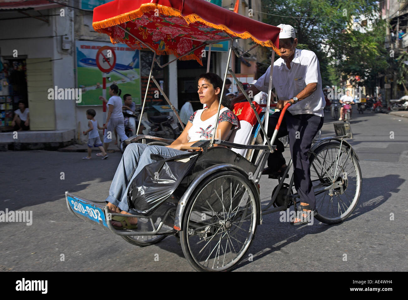 Visitor tours Hanoi Old Quarter by cyclo rickshaw Vietnam Stock Photo ...