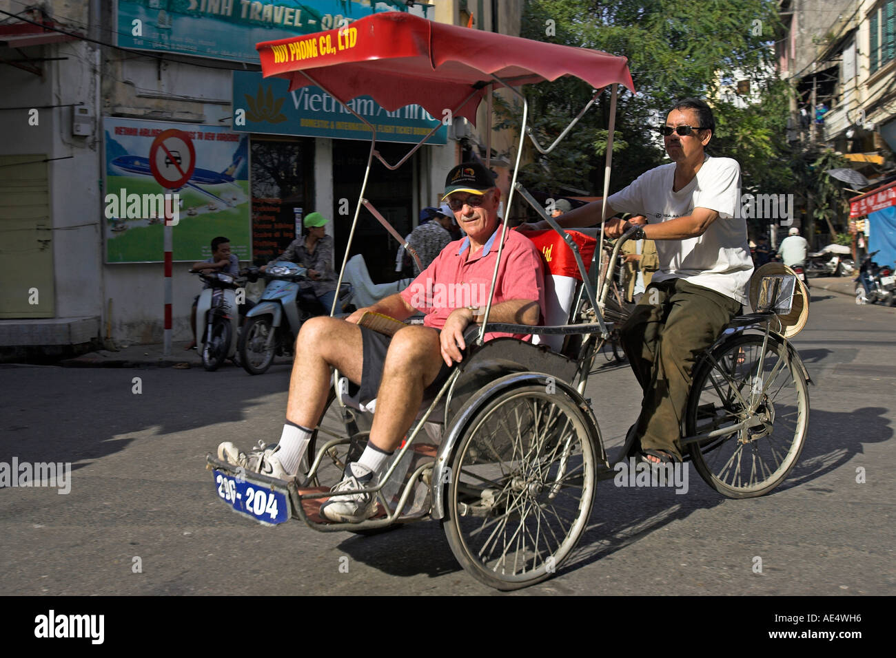 Visitor tours Hanoi Old Quarter by cyclo rickshaw Vietnam Stock Photo ...