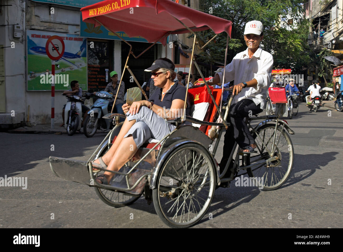 Visitor tours Hanoi Old Quarter by cyclo rickshaw Vietnam Stock Photo ...