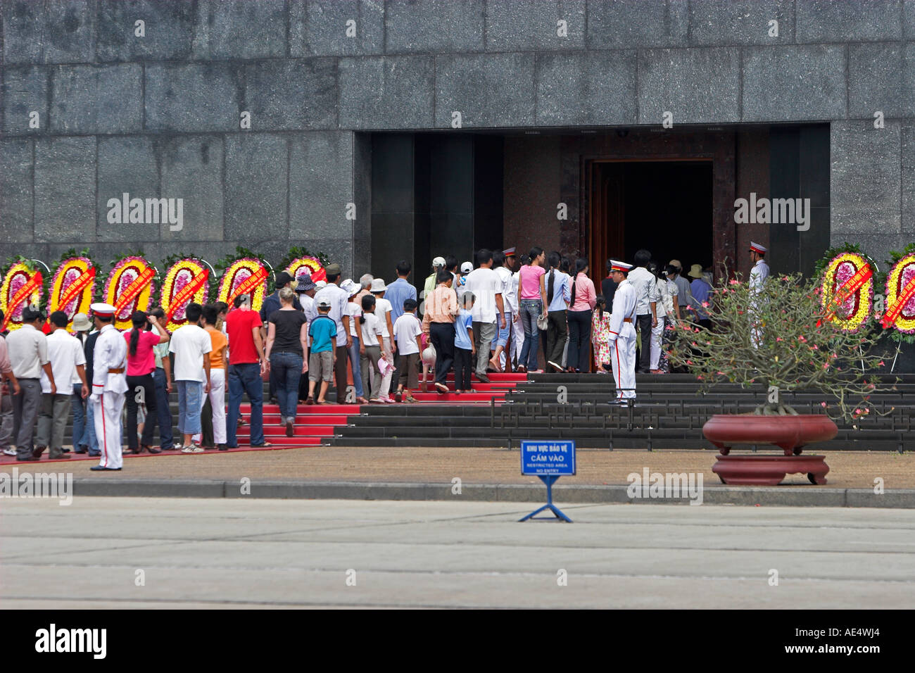 Crowds queue to file through the Ho Chi Minh mausoleum Hanoi Vietnam ...