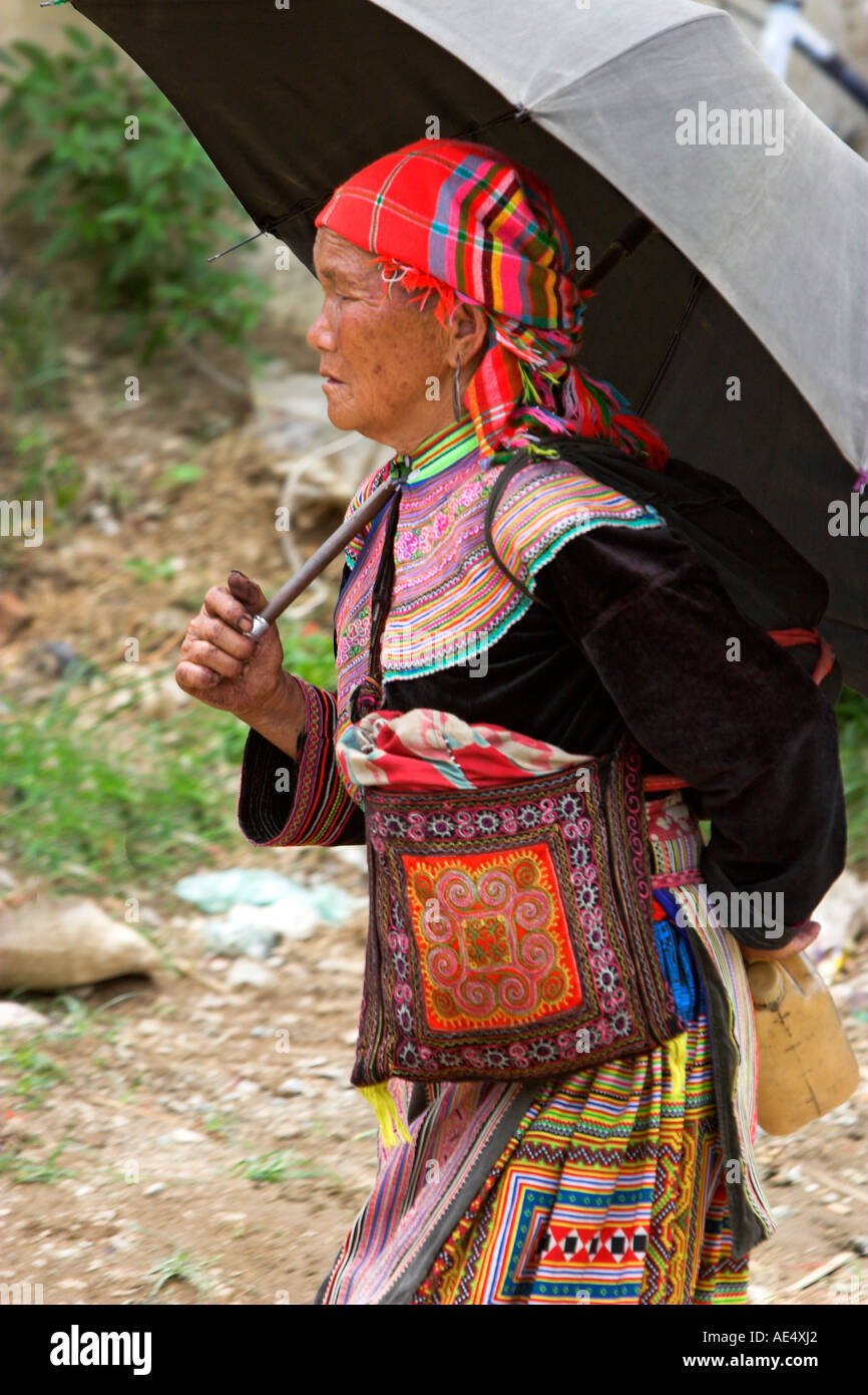 Elderly woman with umbrella sunshade Bac Ha hilltribe market known for ...