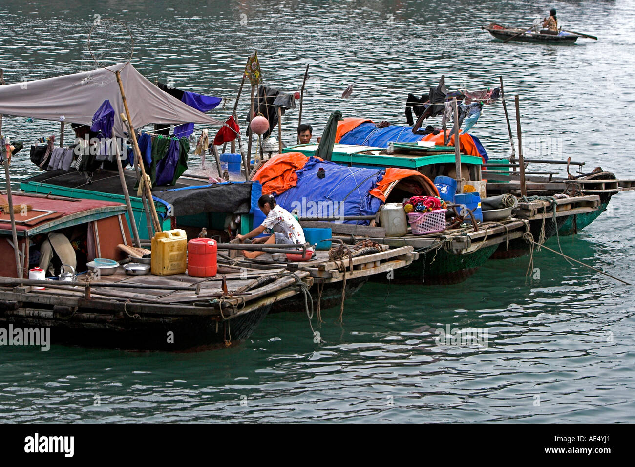 Small fishermens boats rafted up at floating fishing village Halong Bay ...