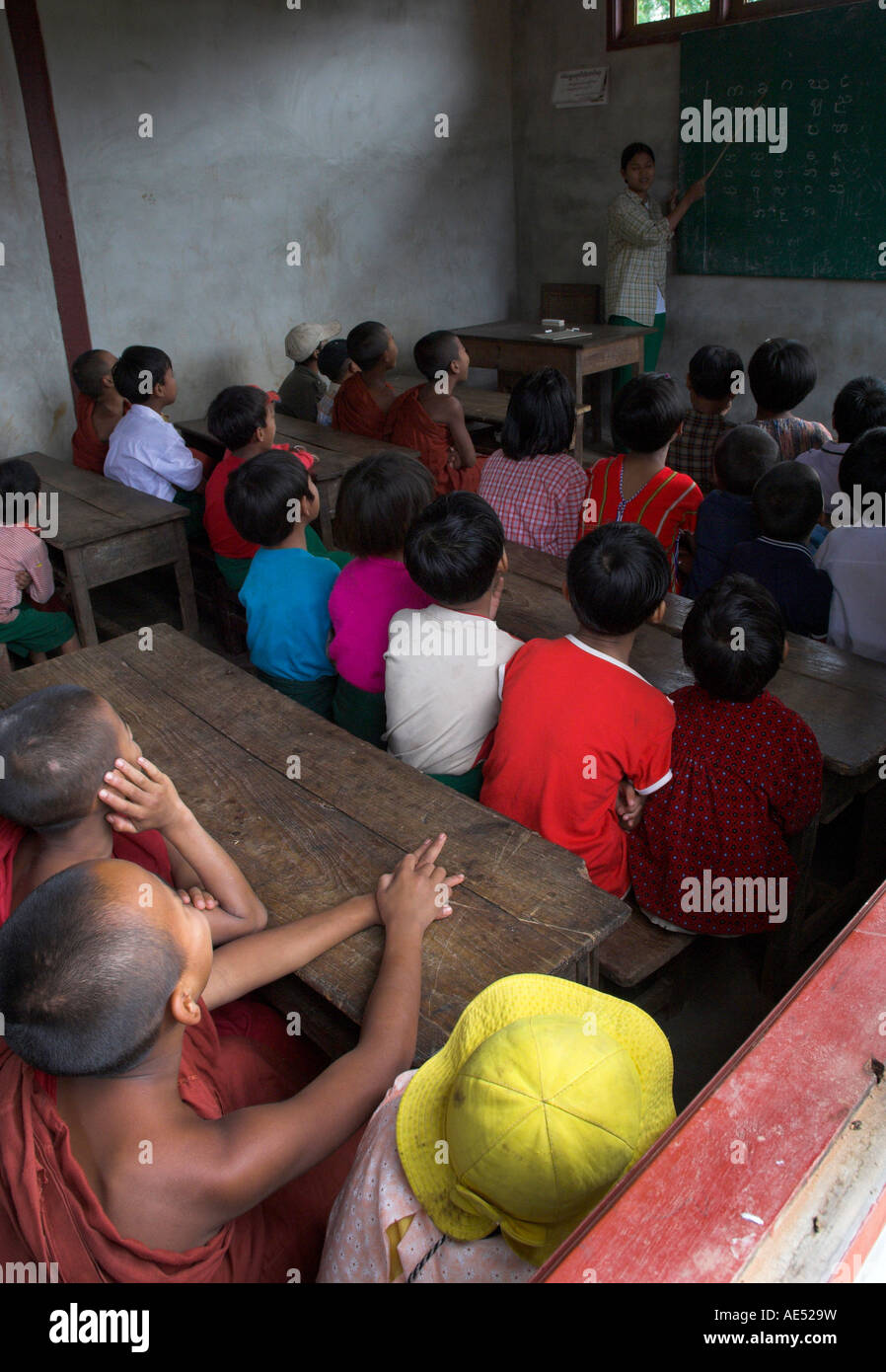 School children in classroom listening to teacher in new school ...