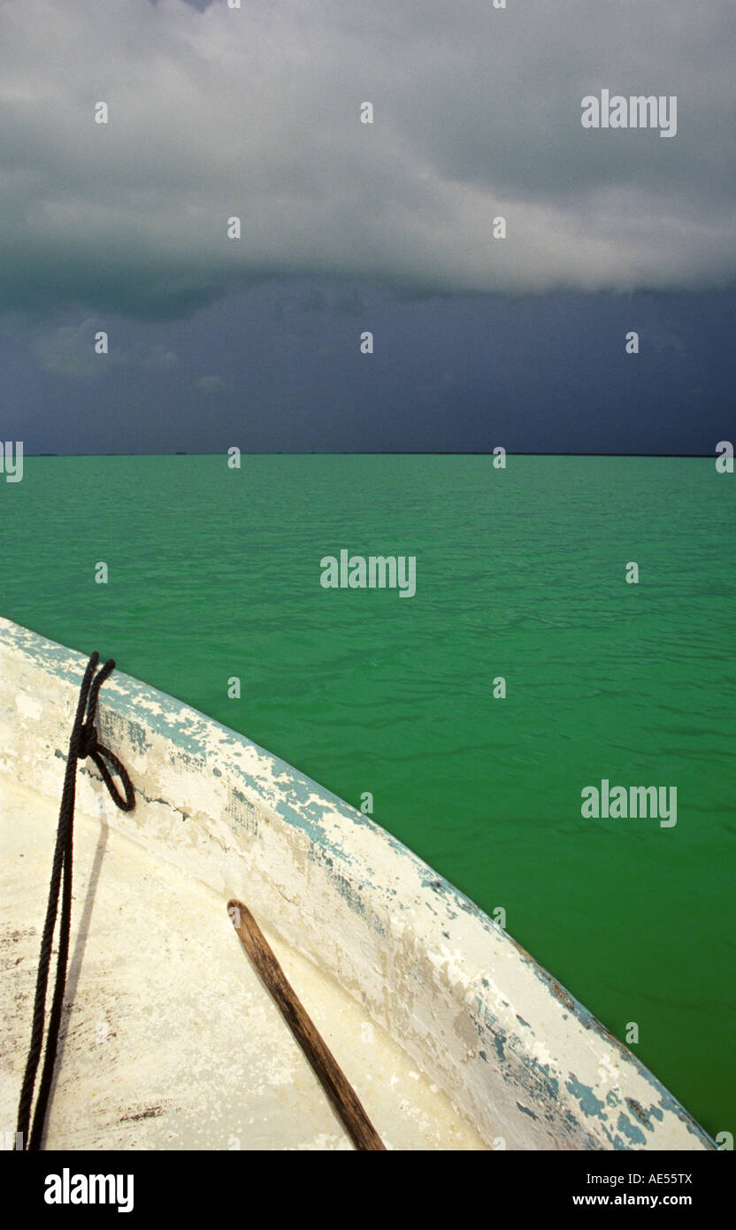 Boat in turquoise waters of Chetumal Bay, Quintana Roo, Mexico, under ...