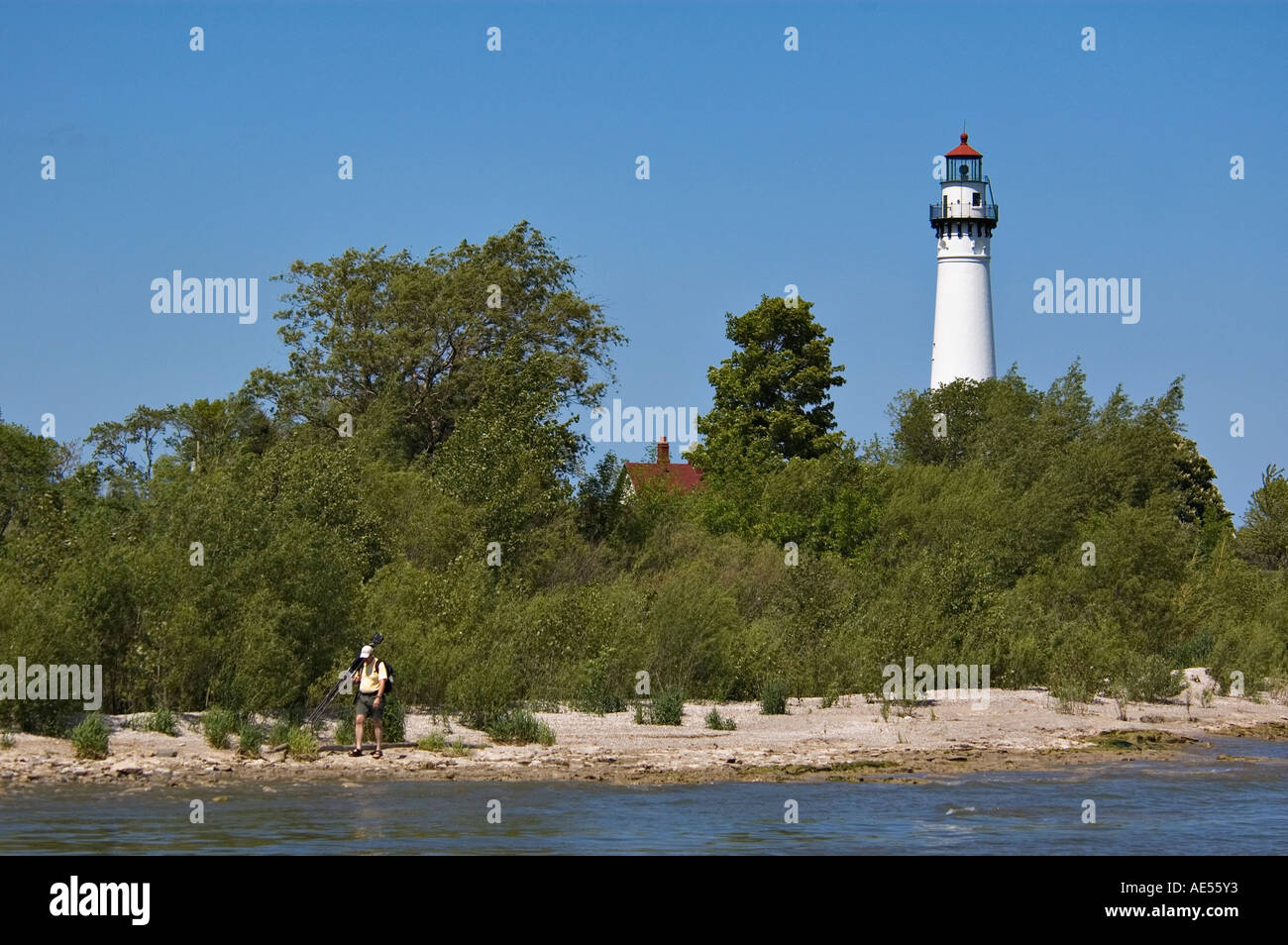 Photographer Walking Along Rocky Lake Shore Near Wind Point Lighthouse ...