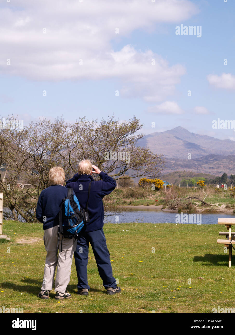 Two birdwatchers using binoculars Porthmadog Gwynedd North Wales UK ...