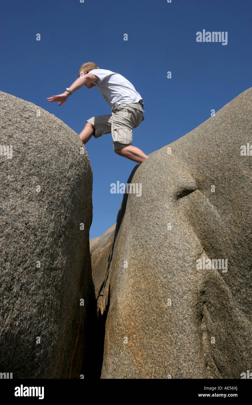 Boy stepping between rocks at Campo Moro, Corsica Stock Photo - Alamy