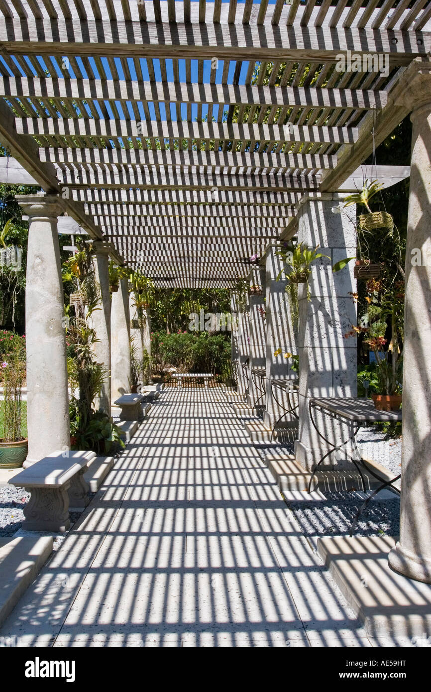 Latticework of trellis casting shadows on a formal outdoor garden patio ...