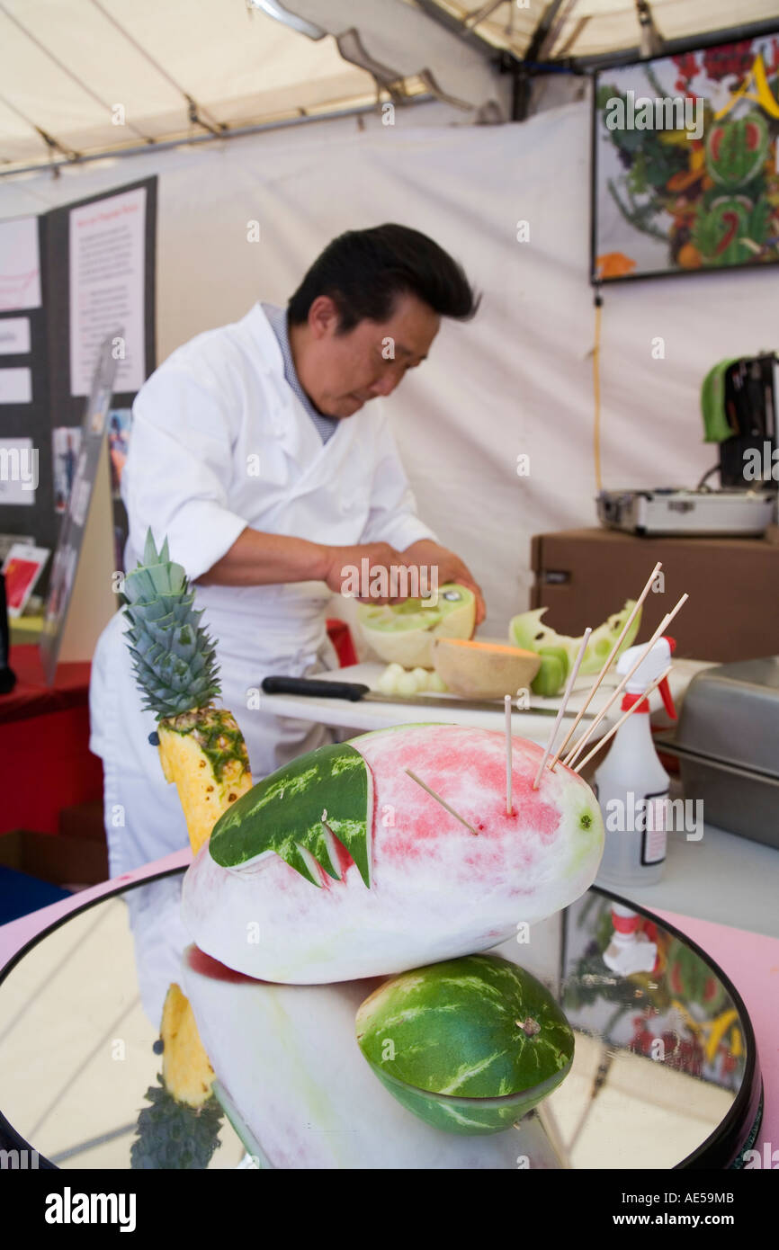 Chef demonstrates fruit carving in booth at the International District ...