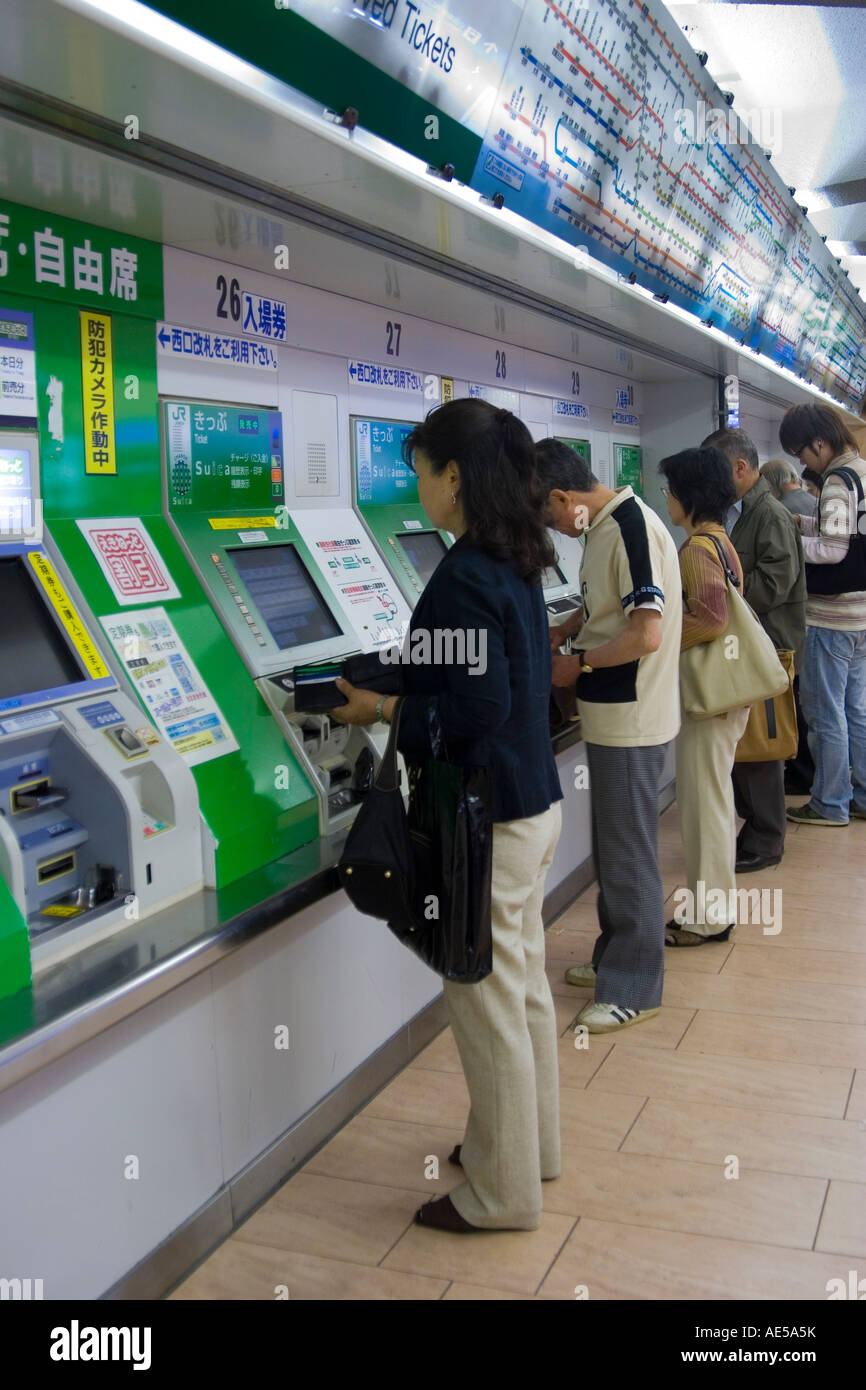 Asian people buying train tickets at electronic ticket booths in ...