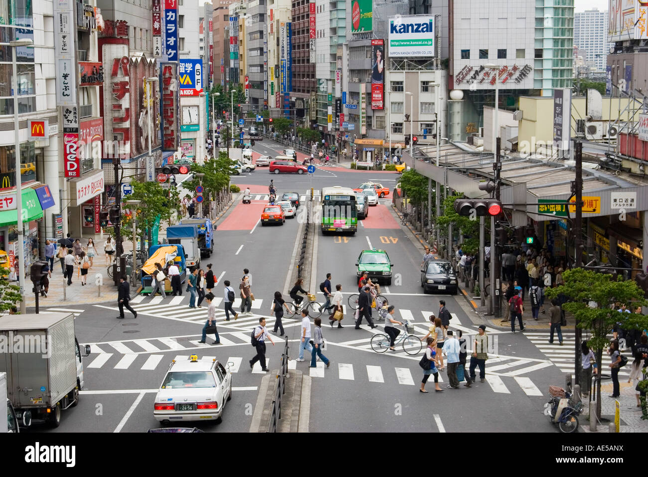Busy street near Shinjuku train station in Tokyo Japan with pedestrians ...