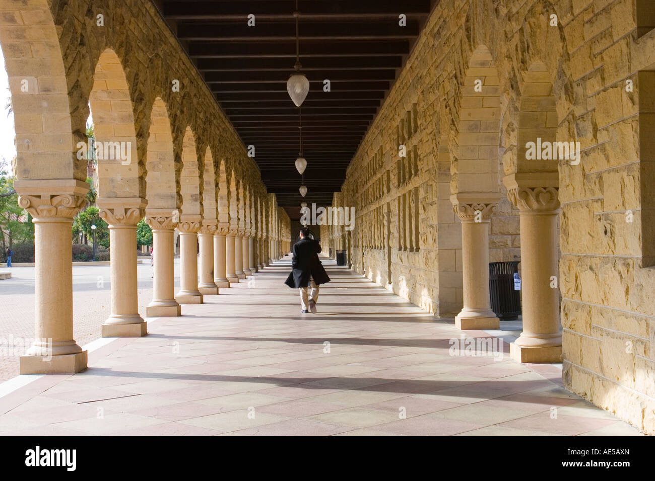 Portico in the Main Quad of Stanford University with a man walking past ...