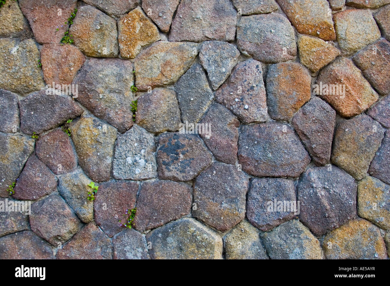 Wall made of large stones of different earth tone colors Stock Photo ...