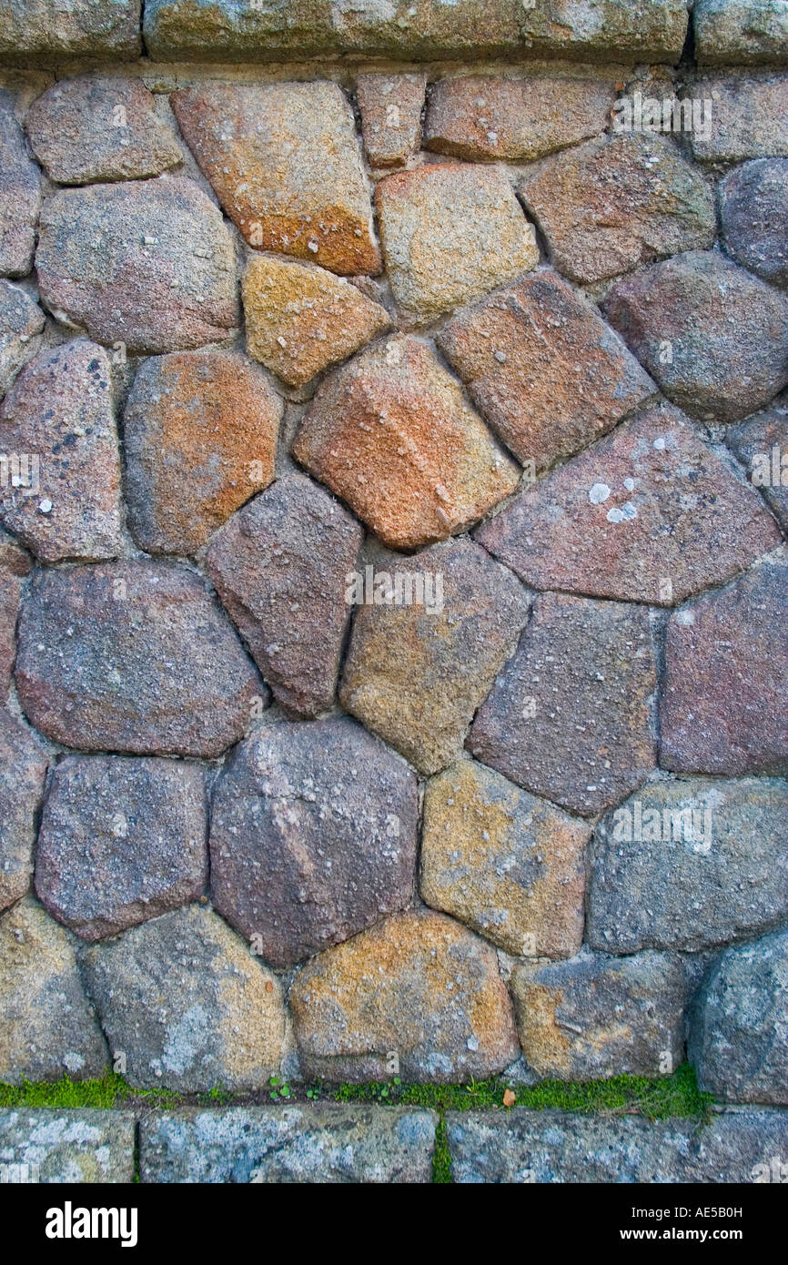 Wall made of large stones of different earthtone colors Stock Photo - Alamy