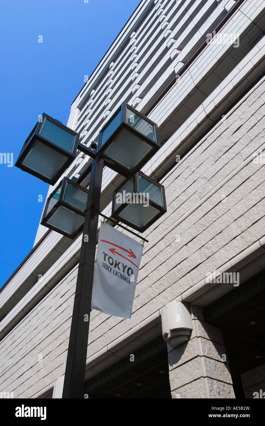 Exterior of the Tokyo Stock Exchange building with banner on a lamppost ...