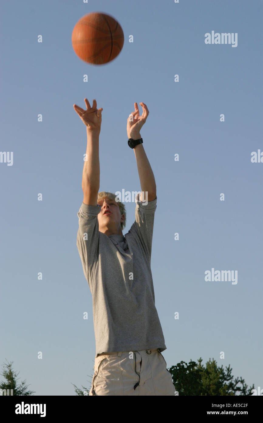 Boy Shooting Baskets Stock Photo - Alamy