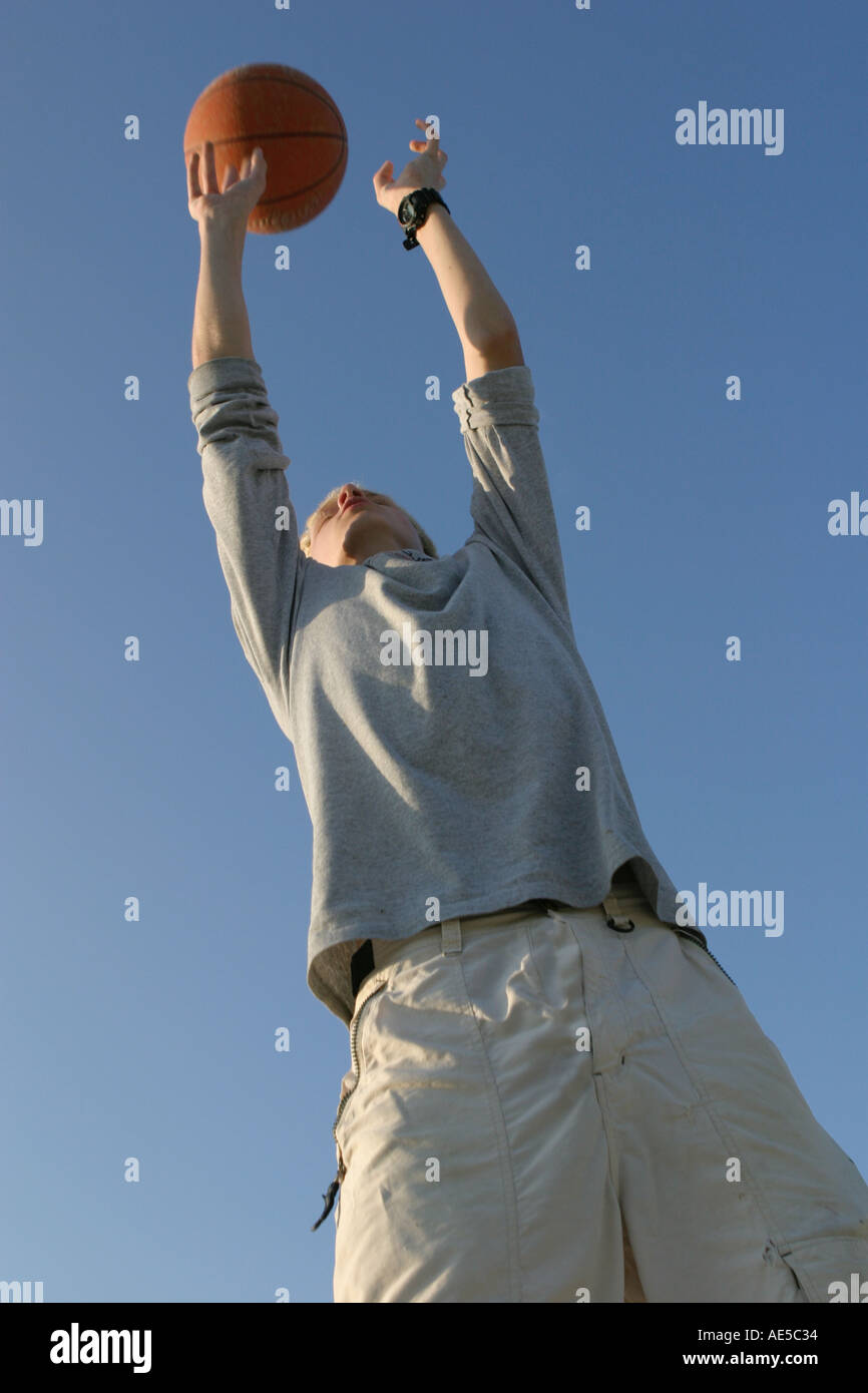 Boy Shooting Baskets Stock Photo - Alamy