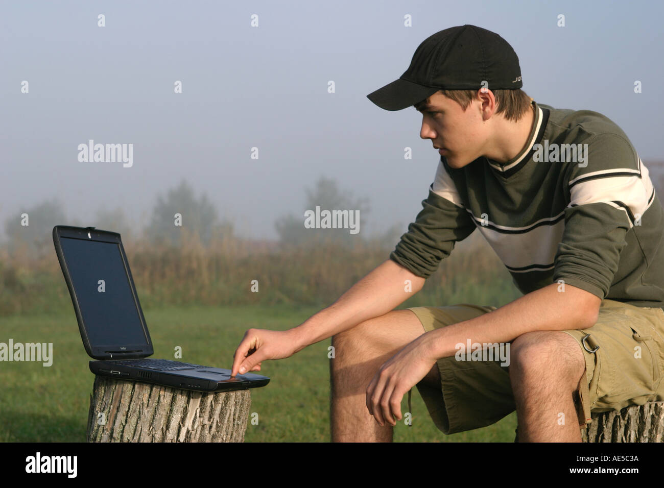 Teen boy laptop outdoors hi-res stock photography and images - Alamy