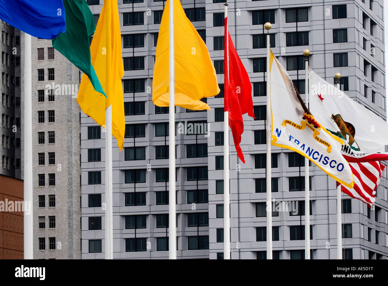 Colourful flags with California flag flying in front of backdrop of ...