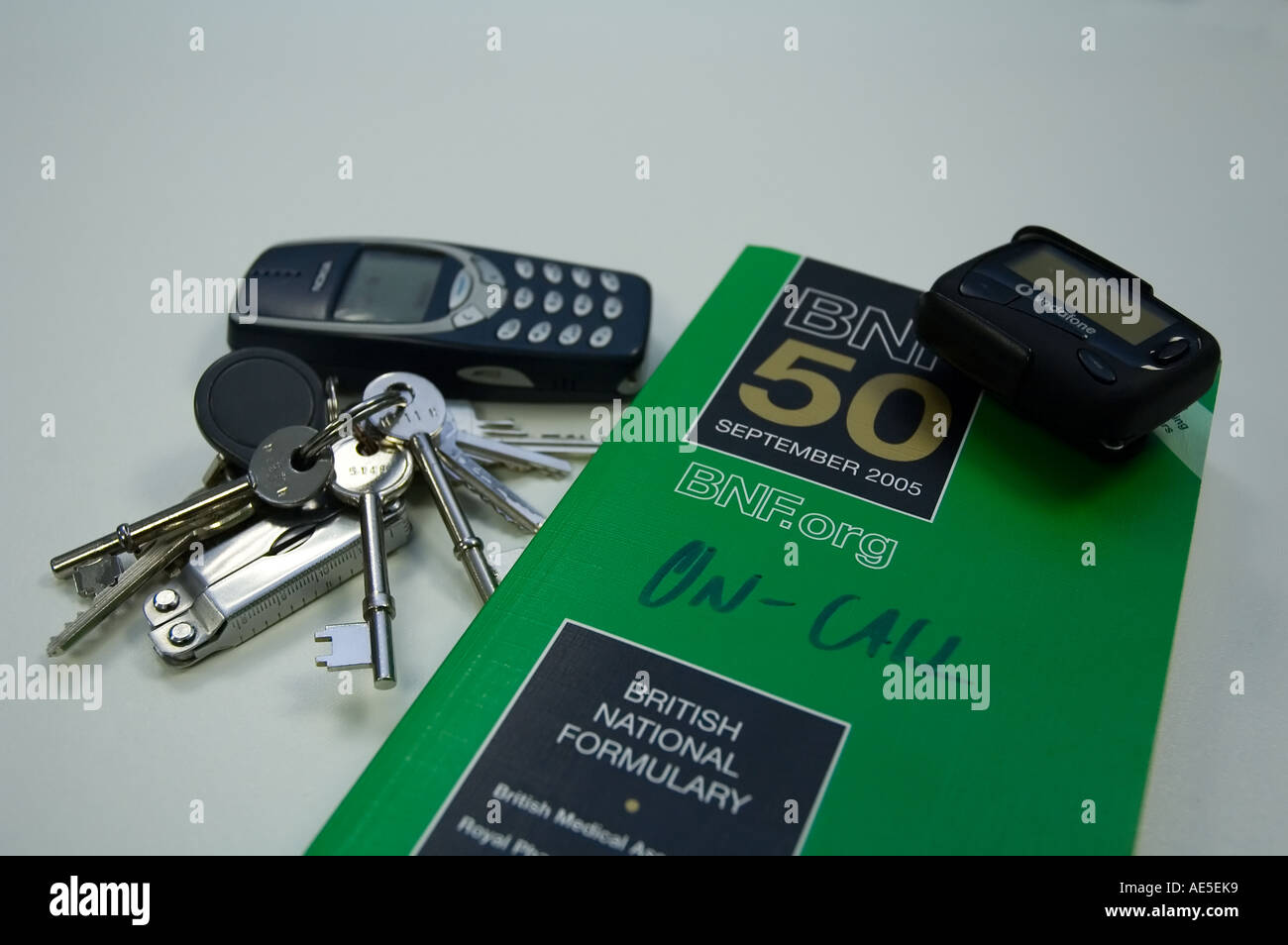 mobile phone pager keys and reference book ready for on call duty Stock ...