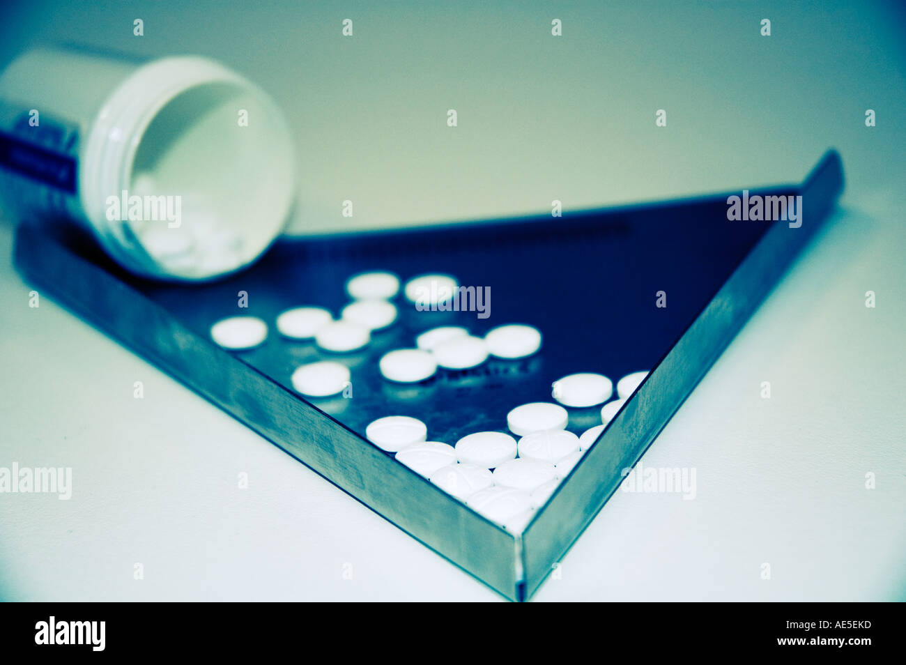 White tablets in a counting triangle Stock Photo - Alamy