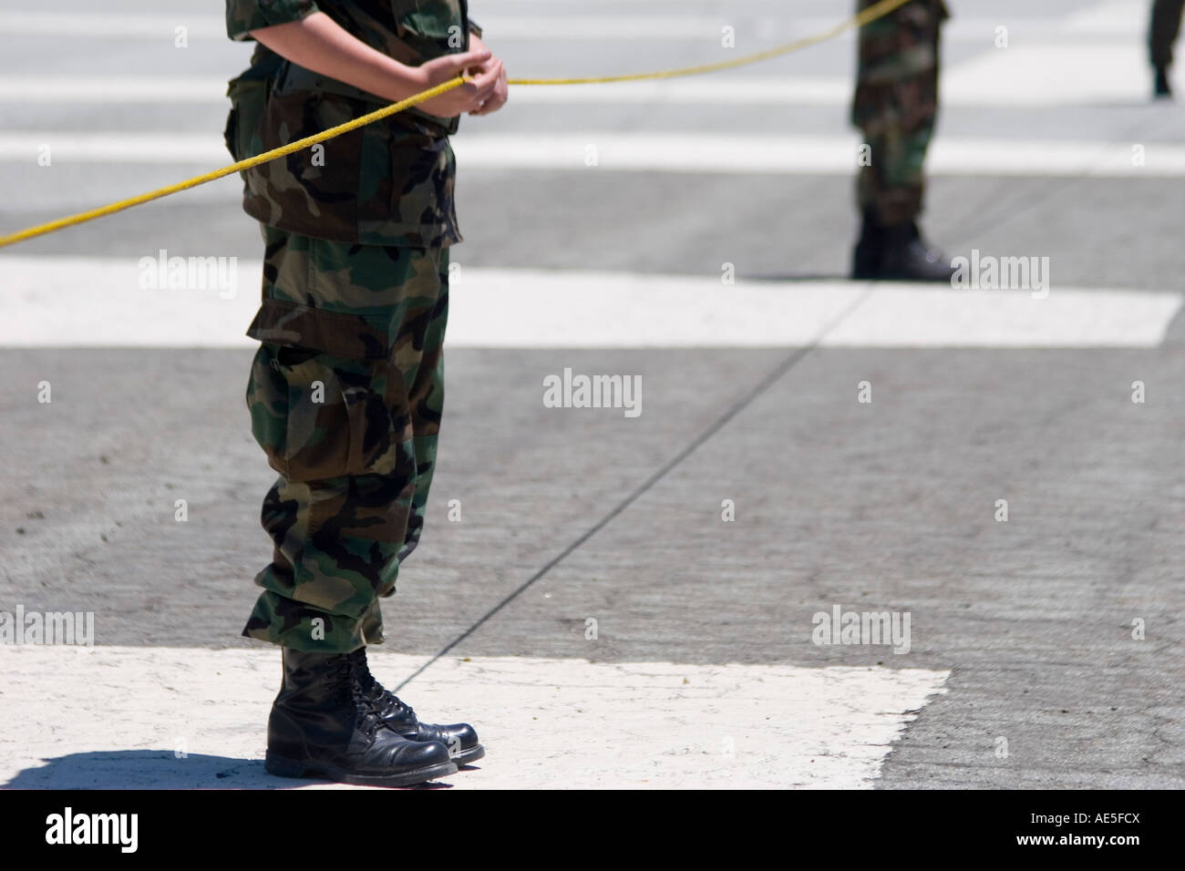 Soldiers in United States national guard holding yellow barricade rope ...